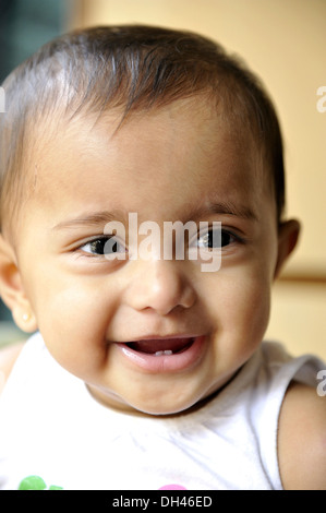 Babies bottom front teeth. Baby girl with open mouth shows her first ...