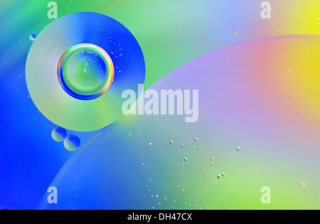 A small drops of oil in water on a blue background Stock Photo - Alamy
