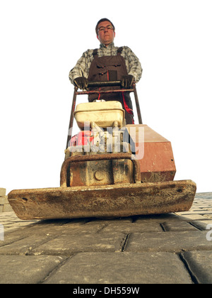 Worker use vibratory plate compactor compacting asphalt at road repair ...