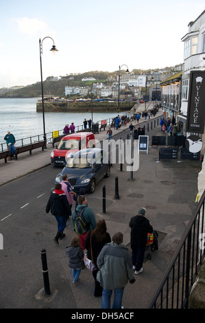The busy harbour of St Ives in Cornwall at low tide with the old town ...
