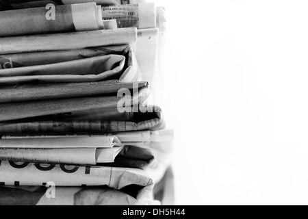 Closeup of newspapers on plain background Stock Photo - Alamy