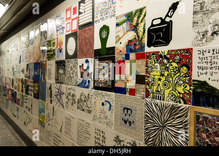 Street Art of poems and paintings on ceramic tiles on a wall in Anguk ...