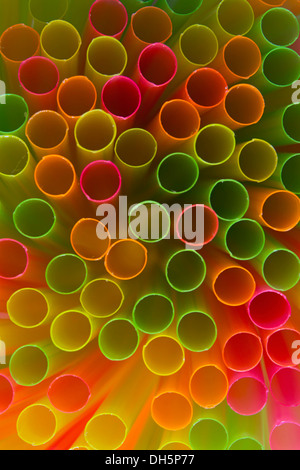 High angle view of drinking straws and plastic plate with ice cubes and ...