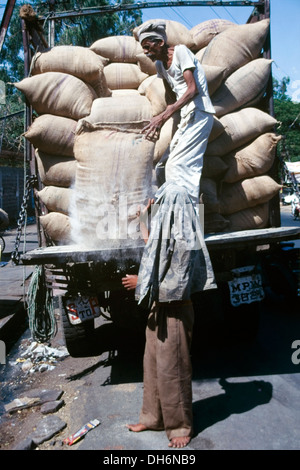 Indian men overloading a truck with sacks of harvested peanuts from a ...