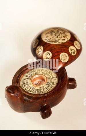 Compass inlaid in a wooden turtle Stock Photo - Alamy