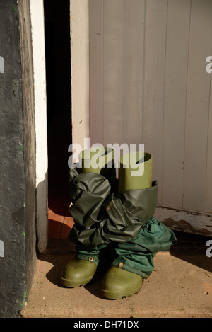 Rubber boots with waterproof pants at door Stock Photo - Alamy