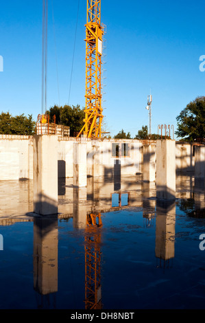The concrete foundations for the columns of a factory building are ...