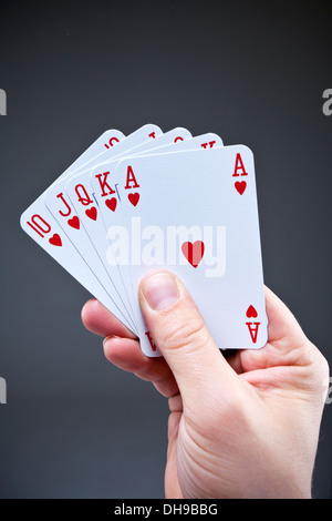 Playing cards being held in mans hand Stock Photo - Alamy