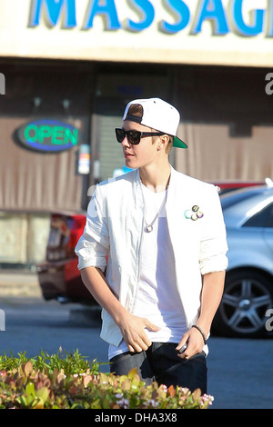 Justin Bieber wears a white jacket and matching baseball cap while out ...