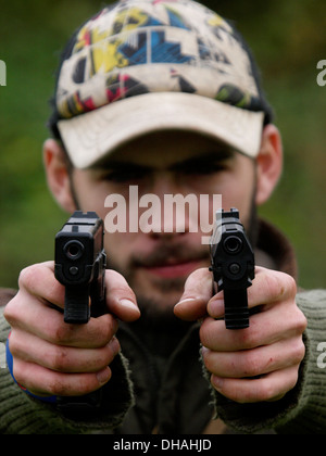 Gangster pointing with their guns at the camera Stock Photo - Alamy