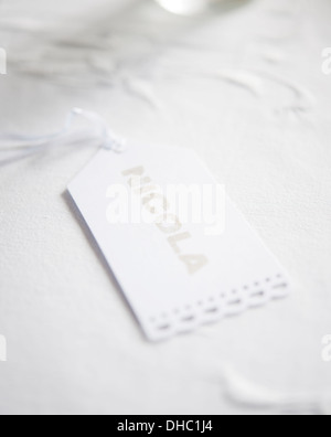 A reception table at a wedding reception with a name tag and a menu ...