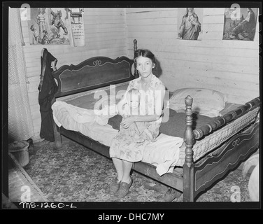 Mrs. Walter Rose, wife of a miner, stands with her two children in the ...
