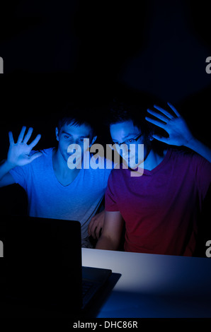 Friends greeting someone through the screen of a laptop Stock Photo - Alamy