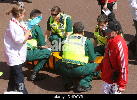 A runner collapsed after running Marathon and is helped by ambulance ...