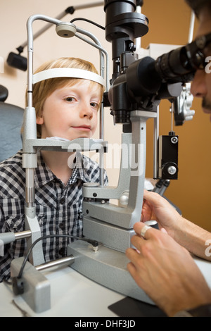 A man having an eye test with Slit Lamp / female doctor in ...