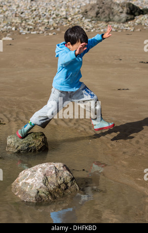 Boy playing in water at the beach Stock Photo - Alamy