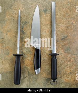 kitchen knife and sharpening stone on a wooden table Stock Photo - Alamy