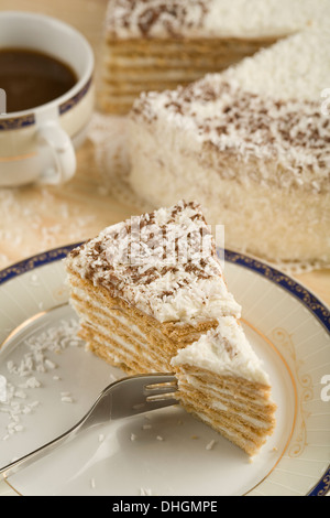 Triangle cut piece of coconut cake Stock Photo - Alamy