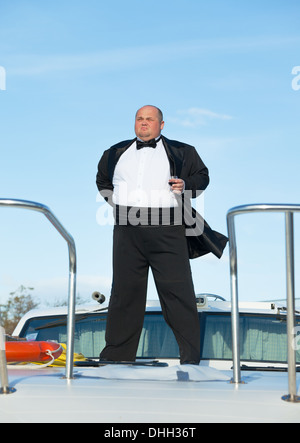 Fat man in tuxedo with glass wine Stock Photo - Alamy