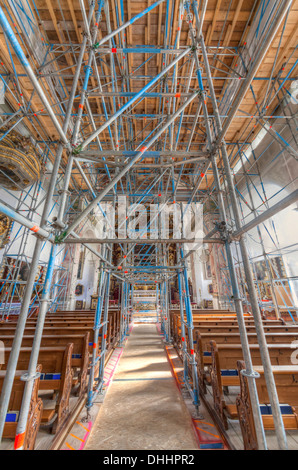 Restoration building site with interior scaffolding and tools in old ...