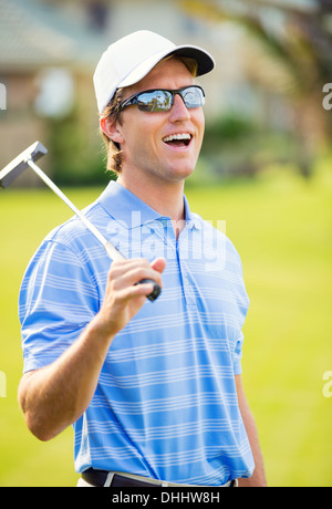 Athletic young man playing golf, Portrait of Golfer on Course with ...