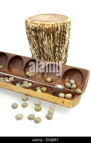 A traditional African wooden game with seeds, the awale. Concept around ...