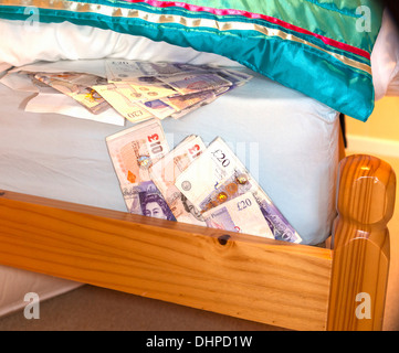 Money hidden under mattress Stock Photo - Alamy