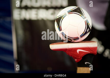Soccer freestyler Marcel Gurk lies on his back and balances a ball on ...