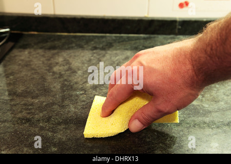 Hand with cloth wiping kitchen surface Stock Photo - Alamy