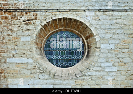 Round stained glass window with reflection on the side wall Stock Photo ...