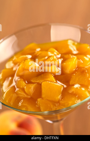 Peach cocktail in glass on light table Stock Photo - Alamy