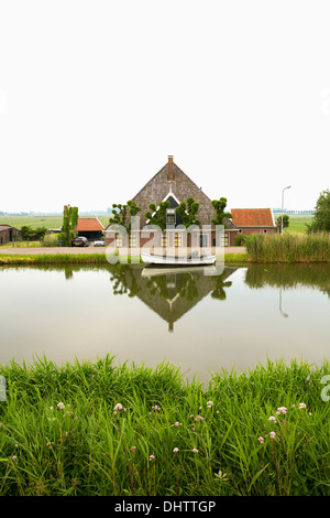 Netherlands, Noordbeemster, Typical farm at belt canal surrounding ...