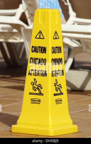 Yellow Caution Slippery Surface cone Stock Photo - Alamy