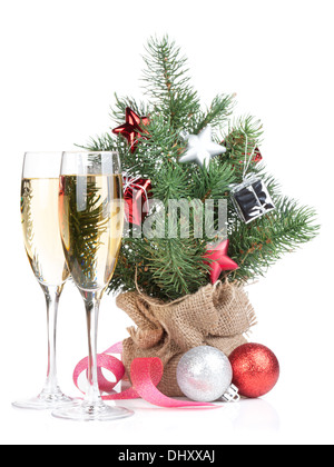 Two glasses of champagne with Christmas toys. Festive lights bokeh ...