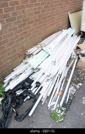 Broken light bulbs and fluorescent tubes collected in a container ...