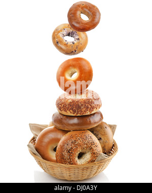 assortment of baked bread falling in straw basket on white background ...