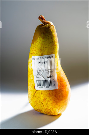 One pear with German bar-coded label showing weight and price in Euro ...