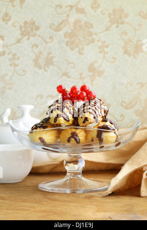choux pastry eclairs on glass stand base, festive dessert Stock Photo ...