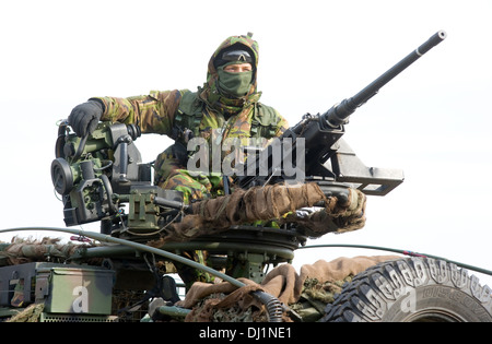 A soldier of the dutch army is aiming his automatic weapon during a ...