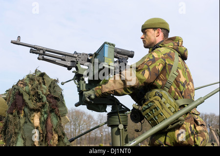 A soldier of the dutch army is aiming his automatic weapon during a ...