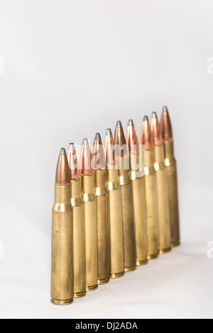 A few rifle bullets lined up in a row on white background Stock Photo ...