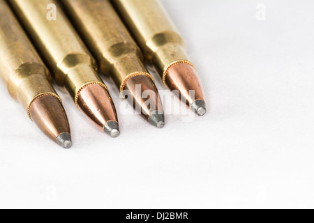 Tips of a few rifle bullets lined up in a row on white background Stock ...