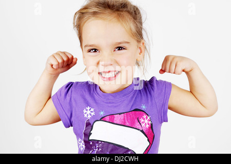 Feeling strong. Child cute girl show biceps power and strength. Girls ...