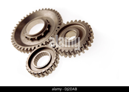 Metal cog gears joining together Stock Photo - Alamy