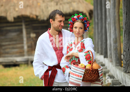 Young ukrainian couple in embroidered national shirts holding hands ...