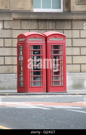 Two Typical red telephone street booths at the famous Picaddilly Circus ...