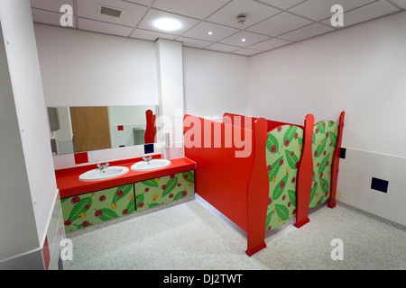 Public restroom with cubicles and wash basins in a vertical format ...