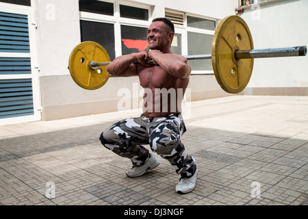 Bodybuilder Doing Front Squats With Barbells Stock Photo - Alamy