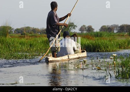 Local Bayei people in the tradiional mokoro dugout boat, Okavango Delta ...