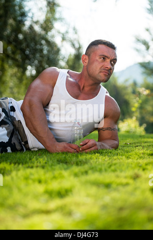 Bodybuilder Holding Water Bottle Stock Photo - Alamy